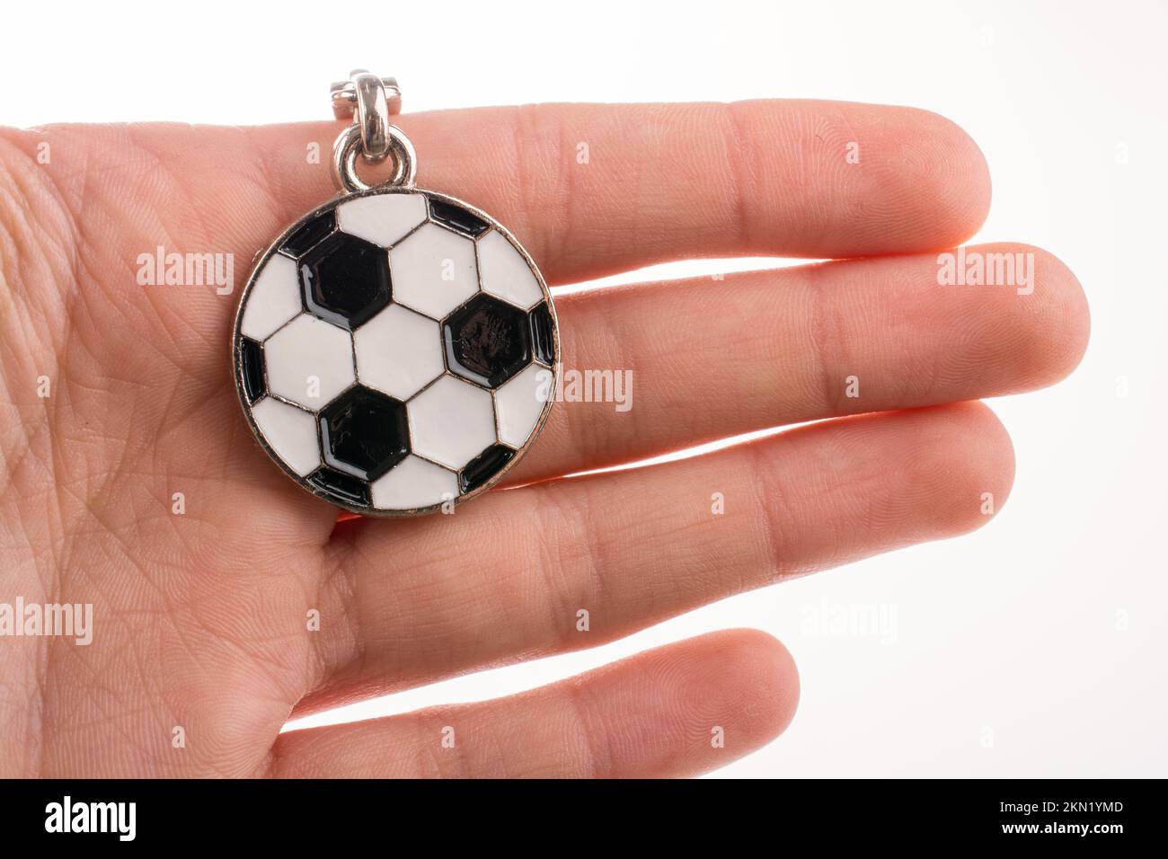 Football shaped keyholder in hand on a white background Stock Photo - Alamy