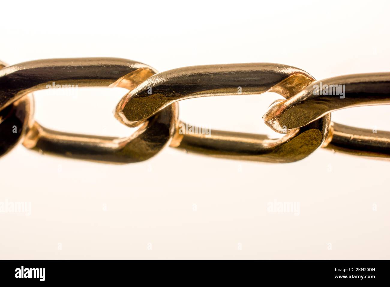 Gold color metal chain on white background Stock Photo - Alamy