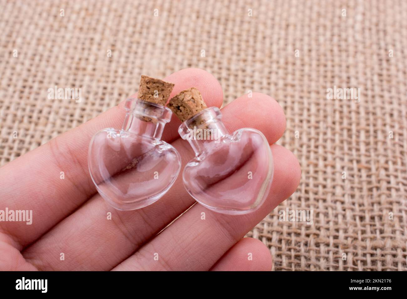 Heart shaped glass bottle is held in hand Stock Photo - Alamy