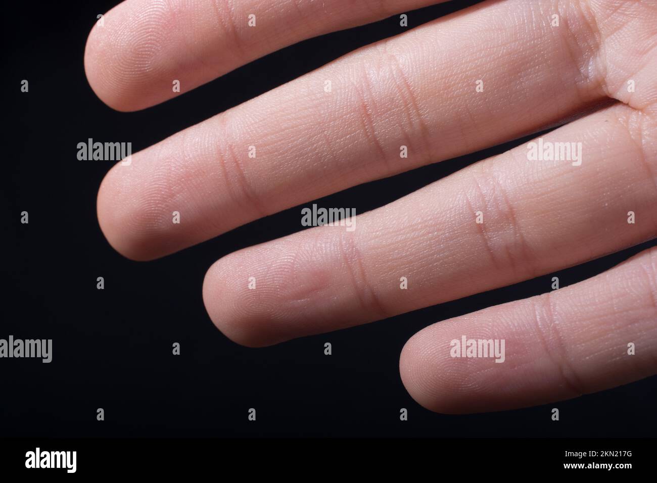 Four fingers of a child hand partly seen in black background Stock ...