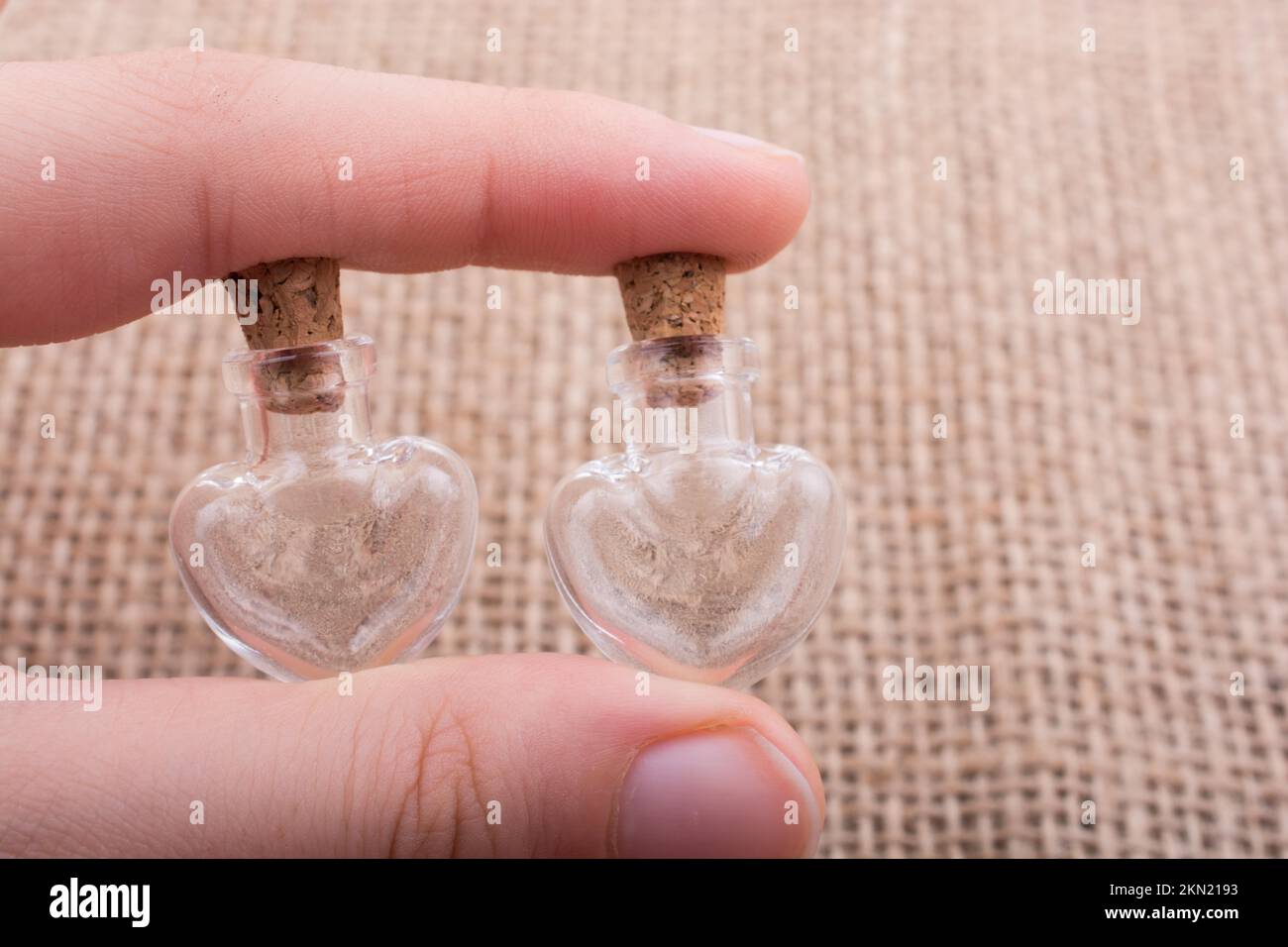 Heart shaped glass bottle is held in hand Stock Photo - Alamy