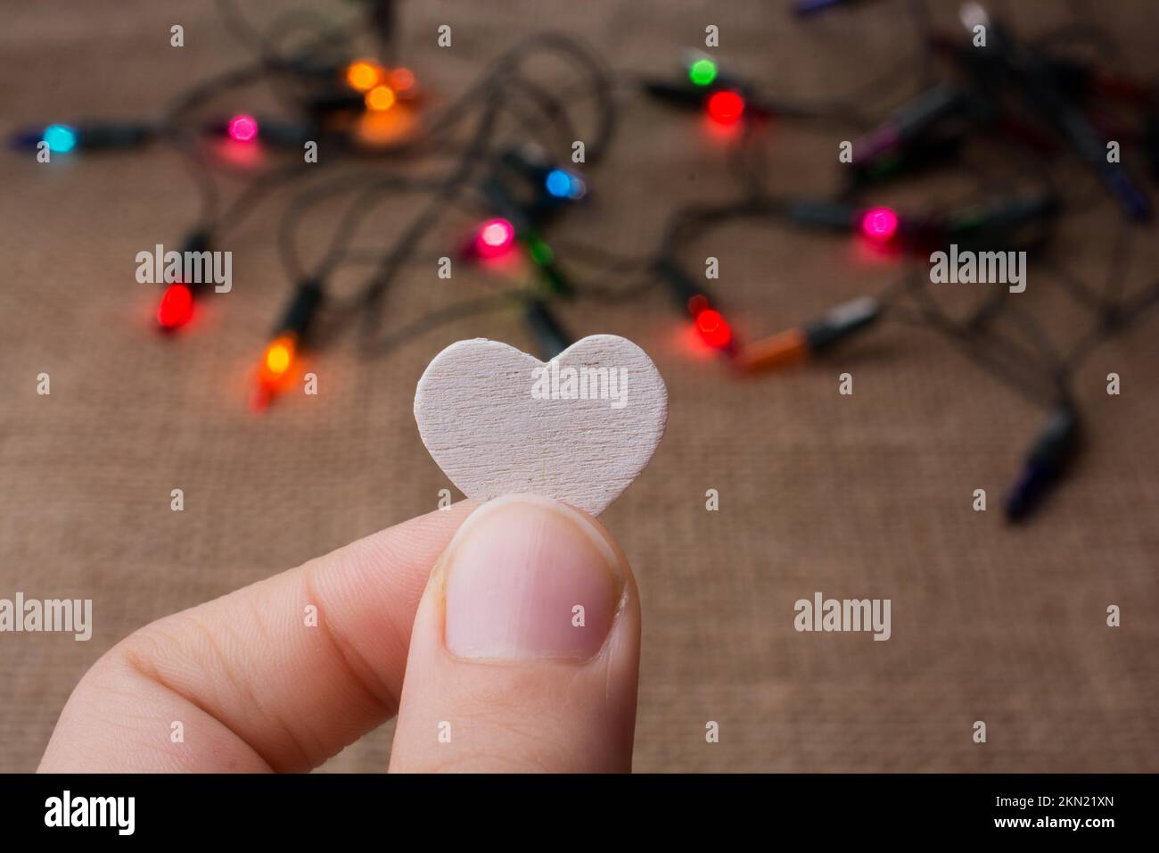 Christmas lights behind heart shaped object Stock Photo - Alamy