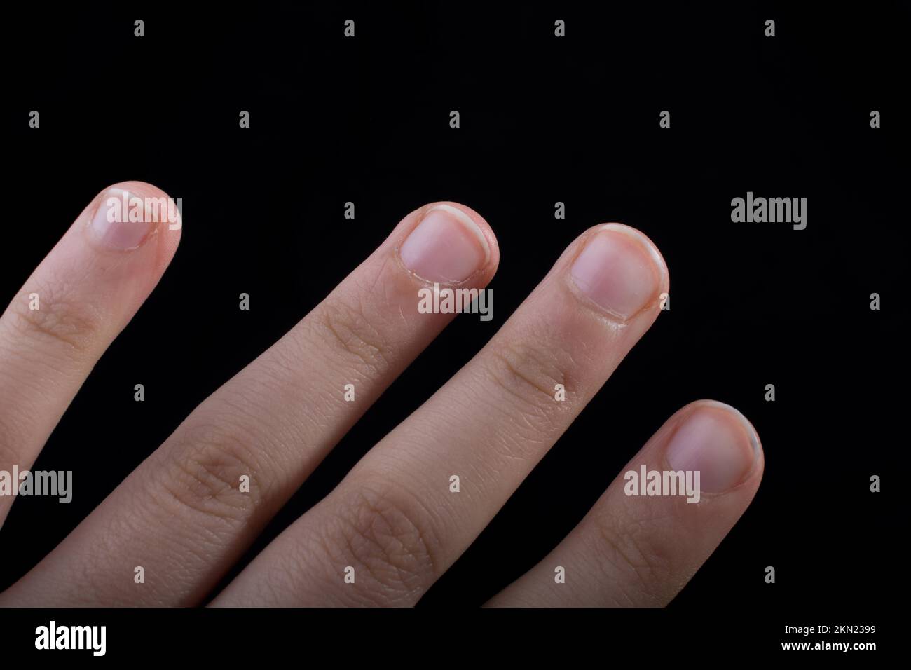 Four fingers of a child hand partly seen in black background Stock ...