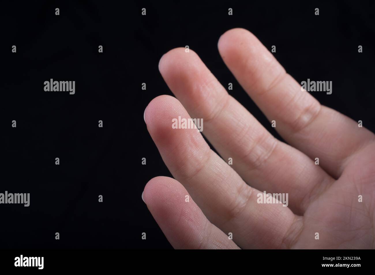 Four fingers of a child hand partly seen in black background Stock ...