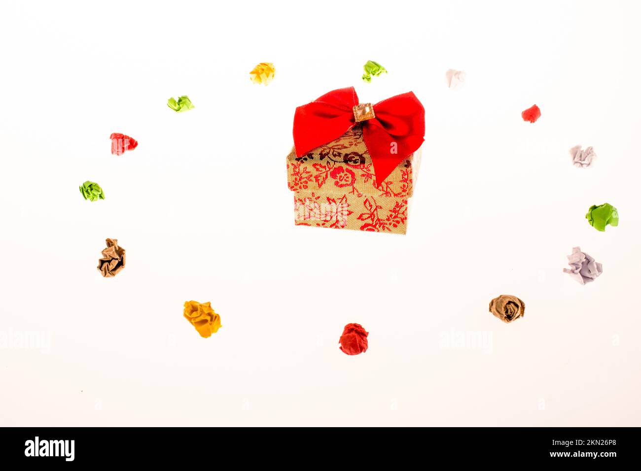 Colorful crumpled papers form a round shape around a gift box Stock ...