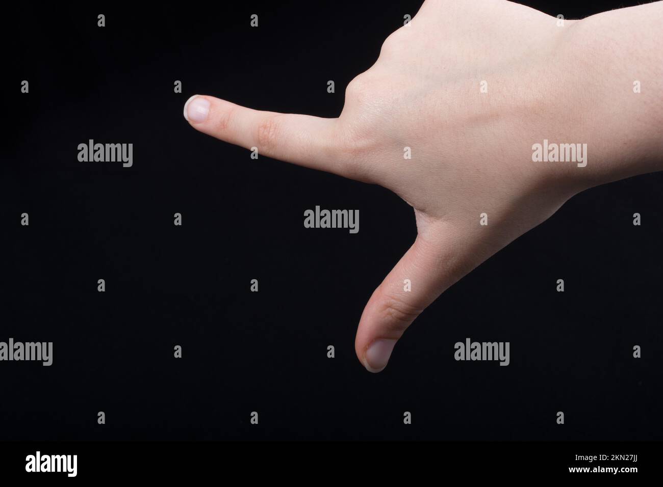 Hand gesture pointing fingers pistol-like handgun on black Stock Photo ...
