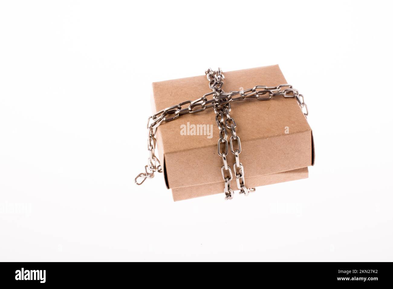Cardboard Box in chains on a white background Stock Photo - Alamy