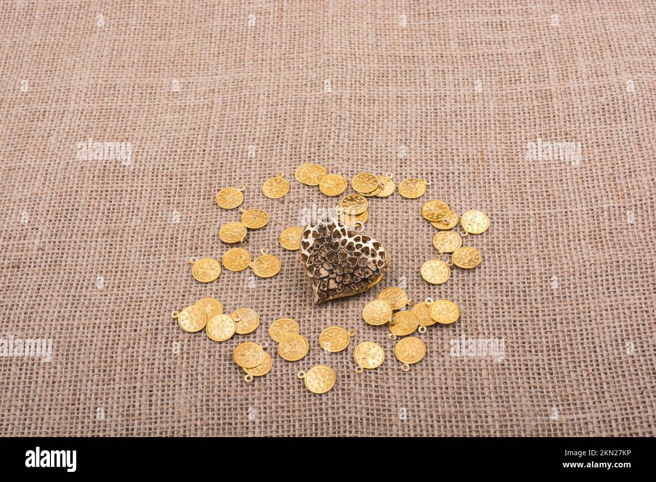 Fake gold coins around heart shape made of paper Stock Photo - Alamy