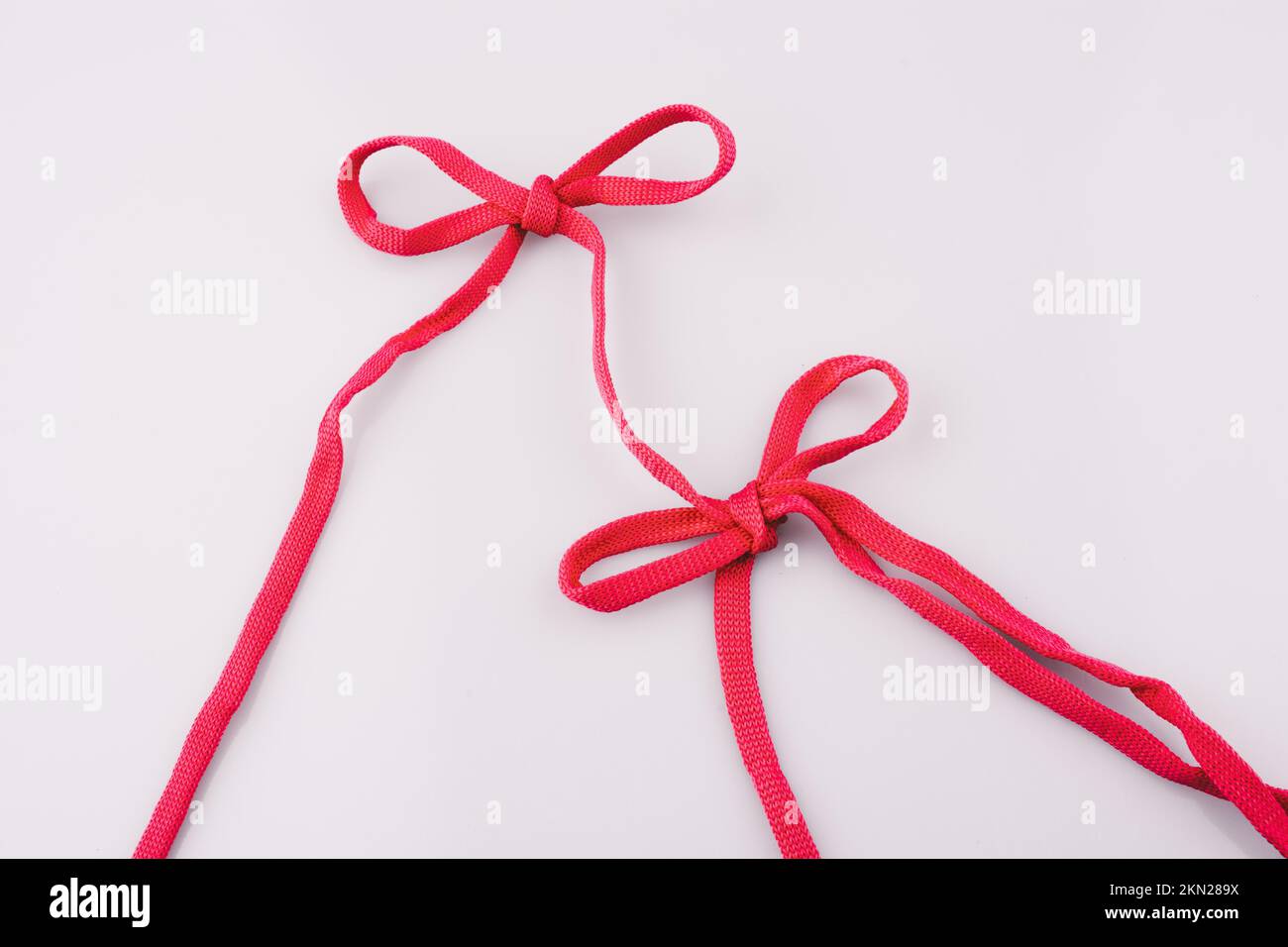Ribbon of shoe lace of red color on plain background in view Stock ...