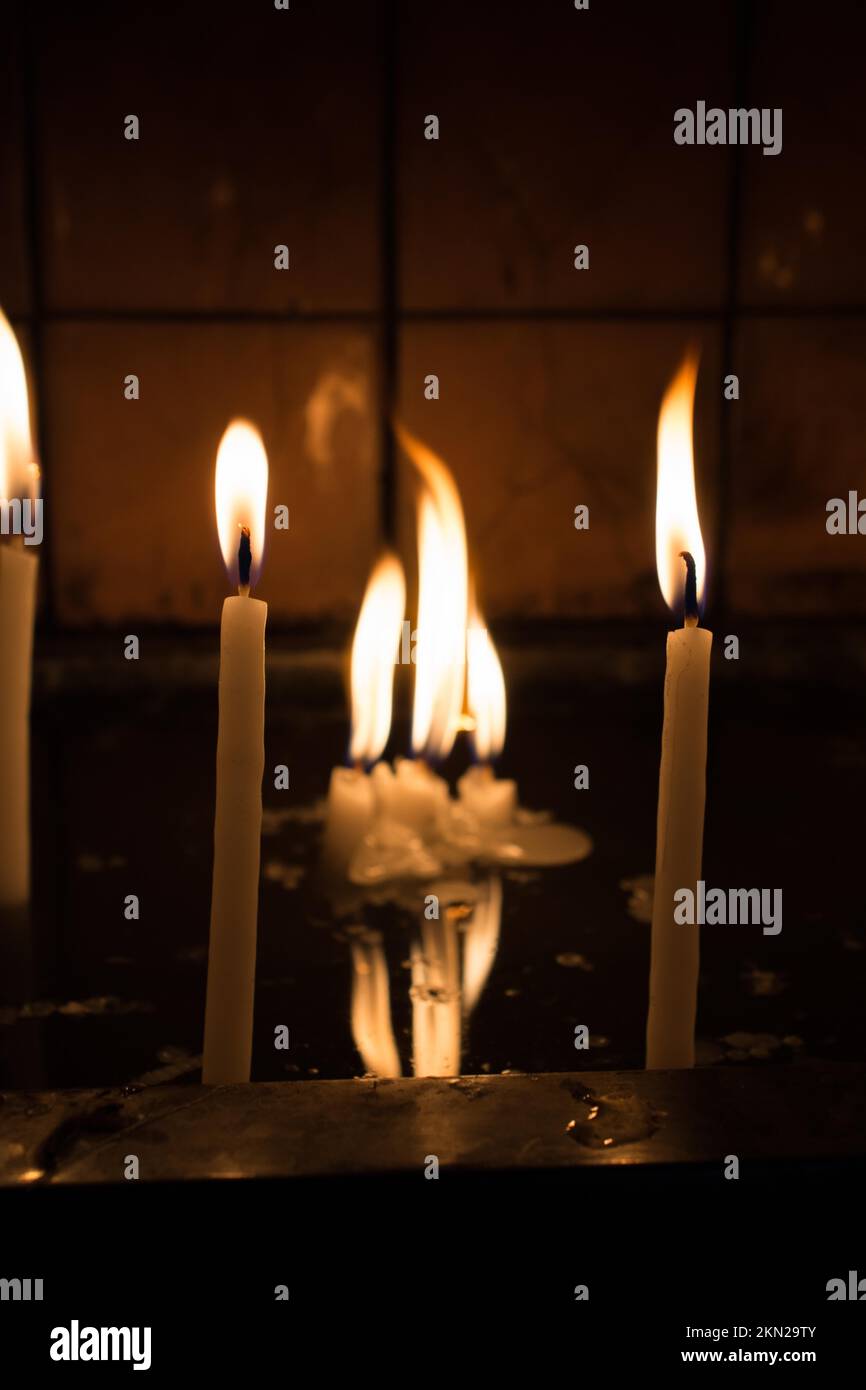 Burning candles with candle light in the dark Stock Photo - Alamy