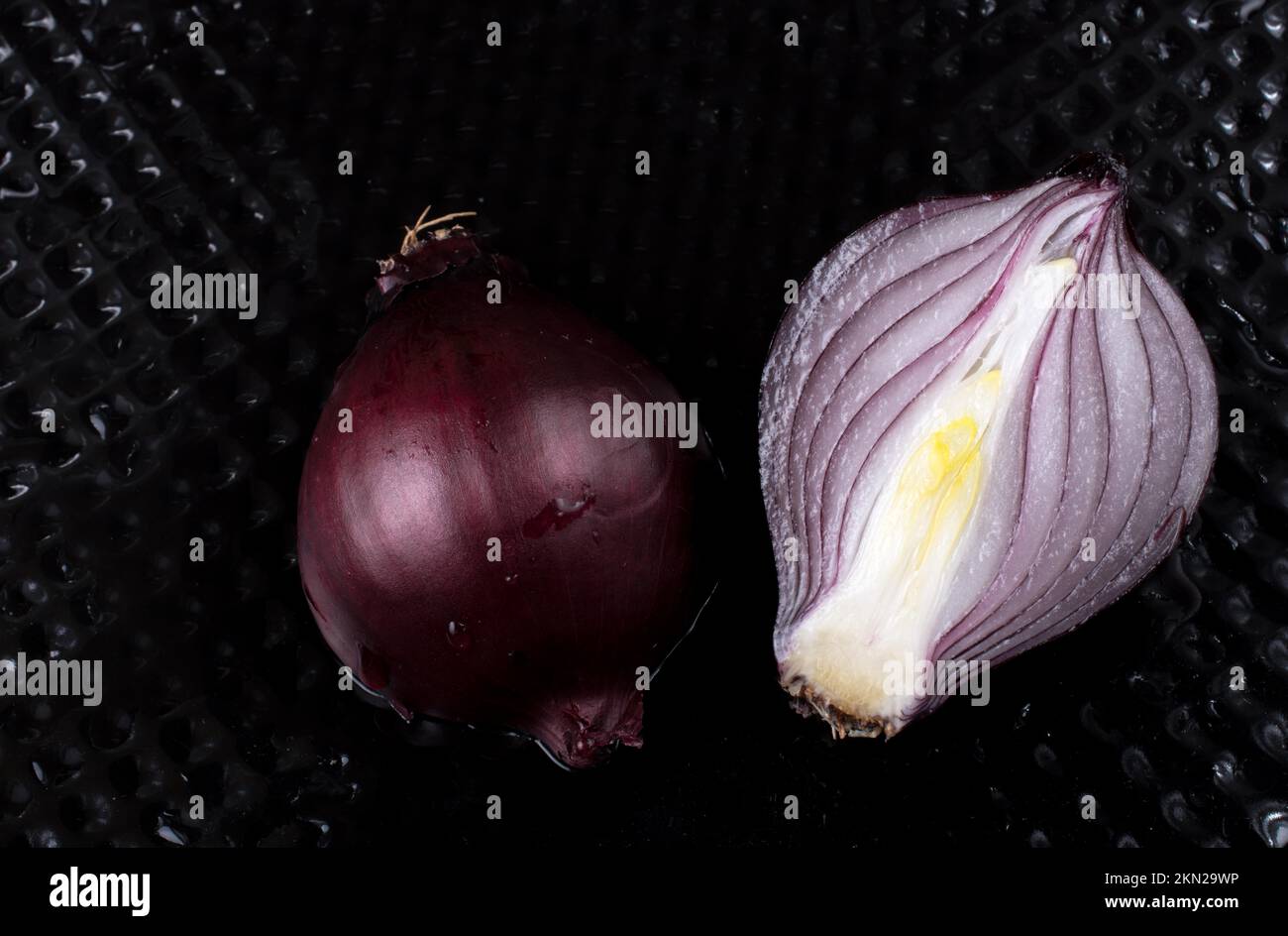 Red onion bulb cut in half on a certain background Stock Photo - Alamy