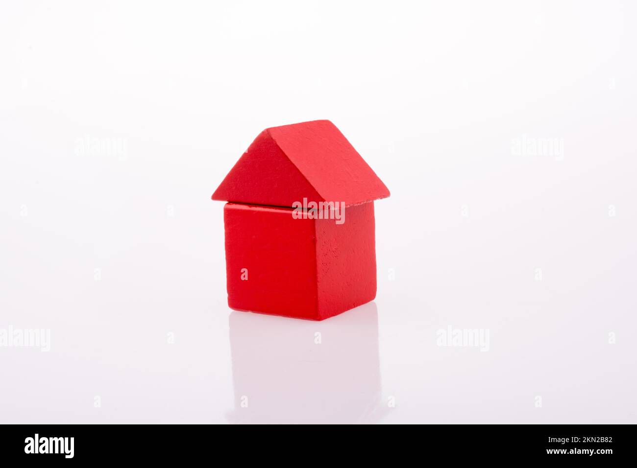House made of red color blocks on a white background Stock Photo - Alamy