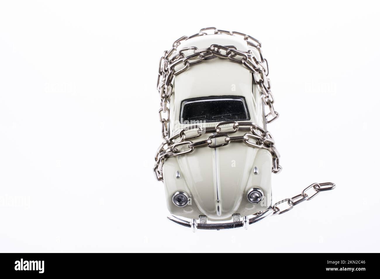 Chained white car on white background Stock Photo - Alamy