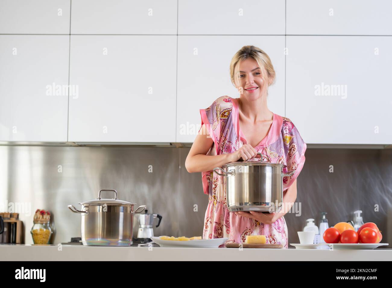 Blond Beautiful Girl With Cooking Pot Cooking In Kitchen Doing