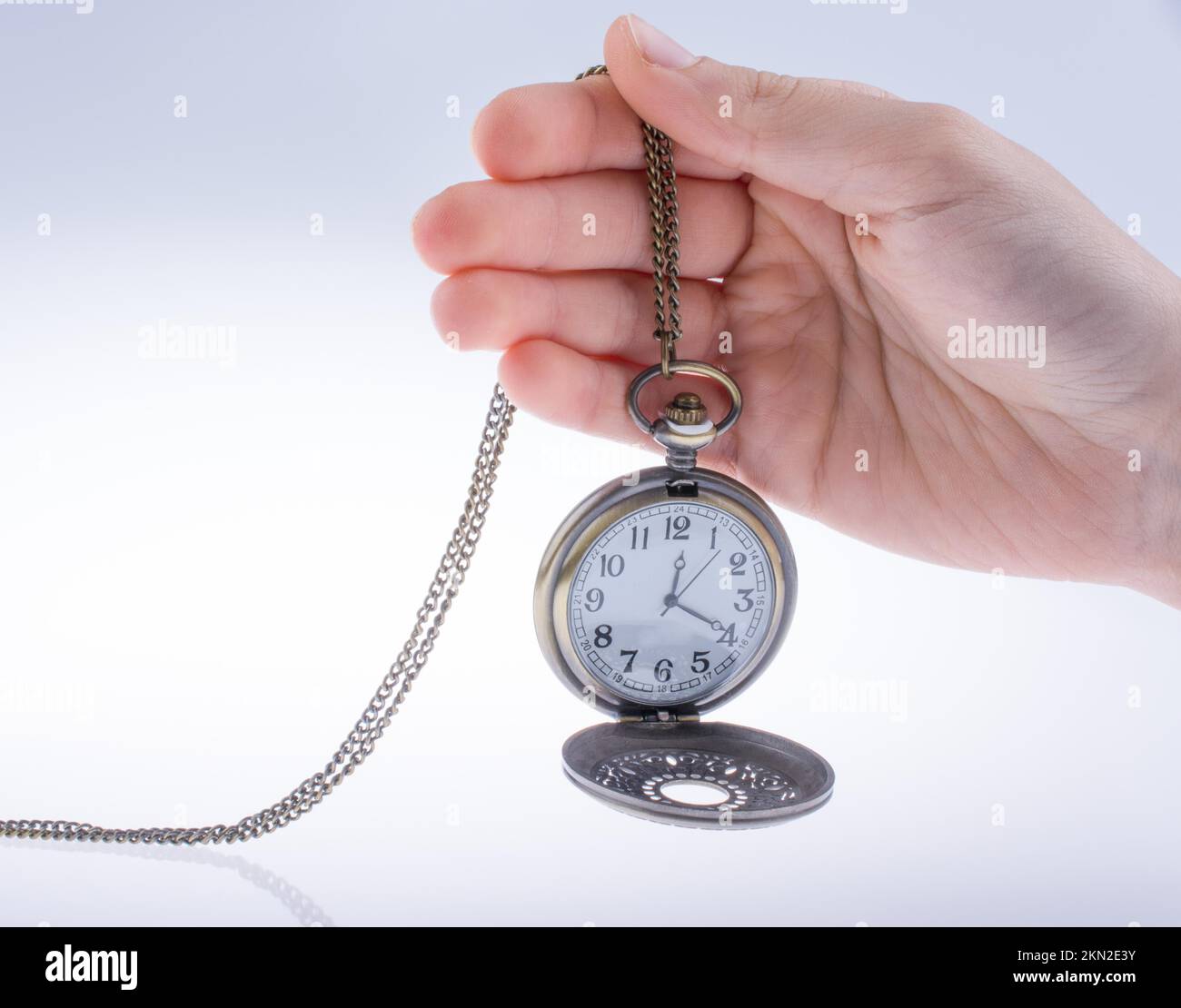 Hand holding a retro styled pocket watch in hand Stock Photo - Alamy