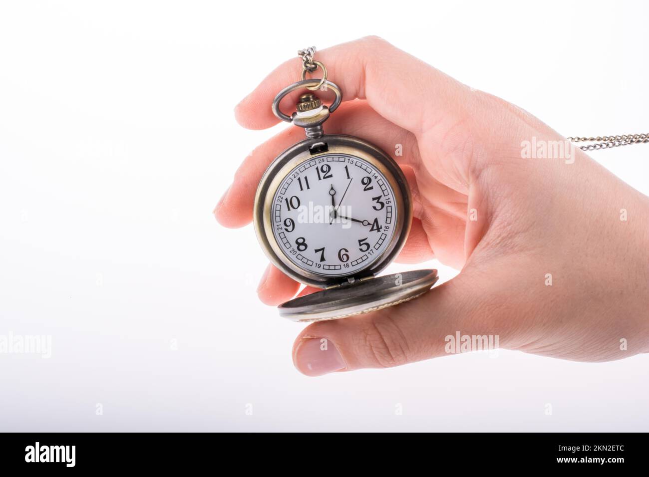 Hand holding a retro styled pocket watch in hand Stock Photo - Alamy