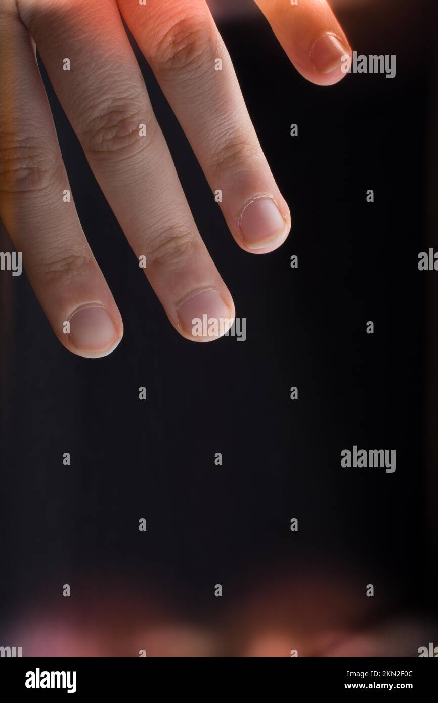 Four fingers of a child hand partly seen in black background Stock ...