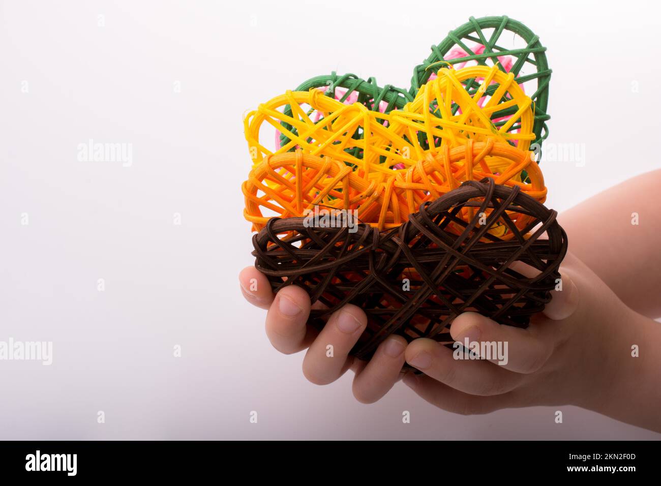 Handmade straw heart or valentines day object in hand Stock Photo - Alamy