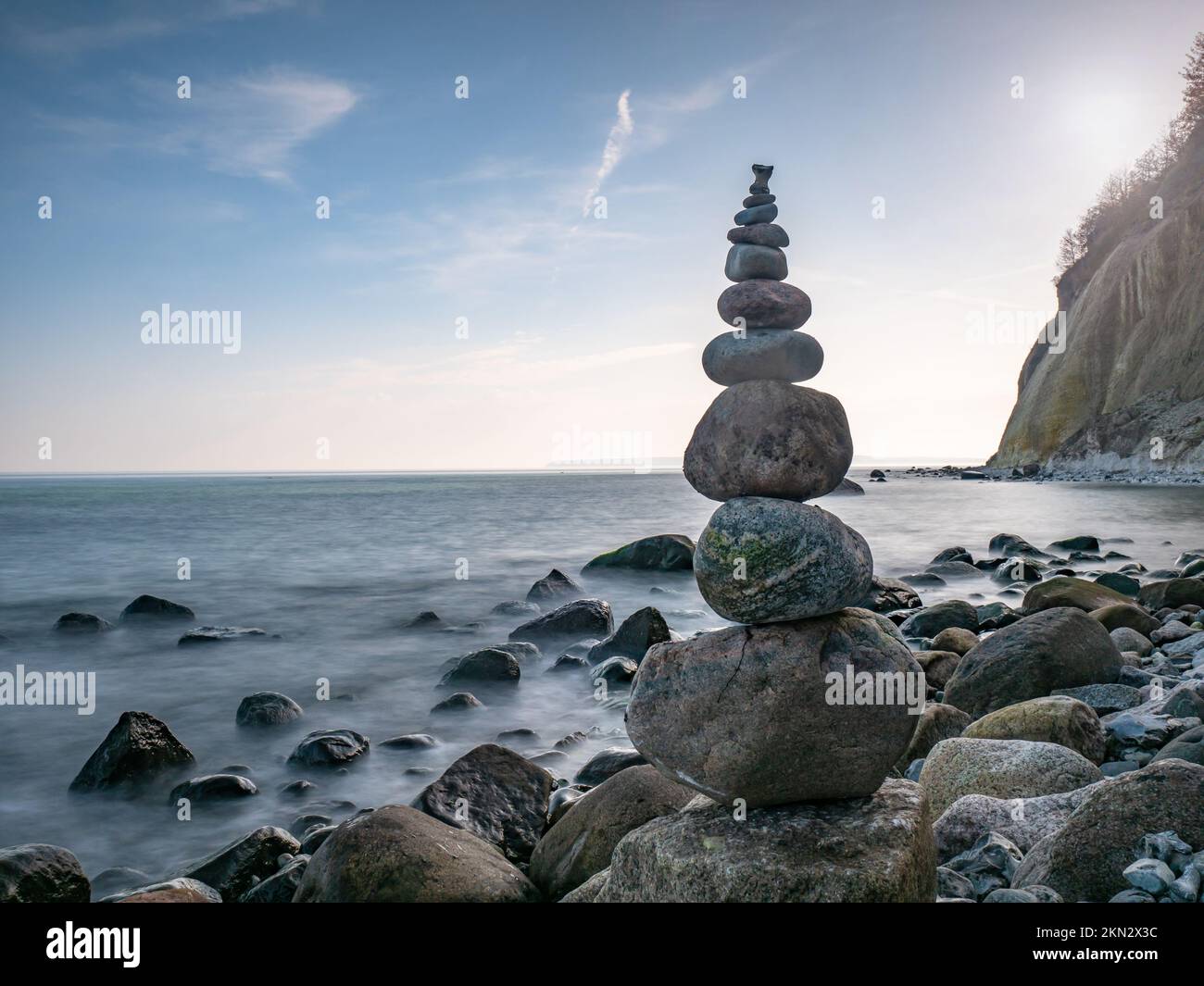 Stacked pebbles in stony pillar bellow white cliff of Cape Arkona. The ...