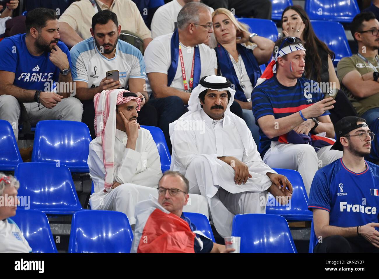 two Qataris sit in their traditional robes in the stands among French ...