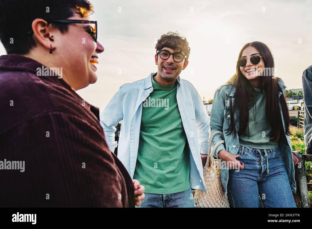 Happy group of best friends converse together outdoors - cheerful young ...