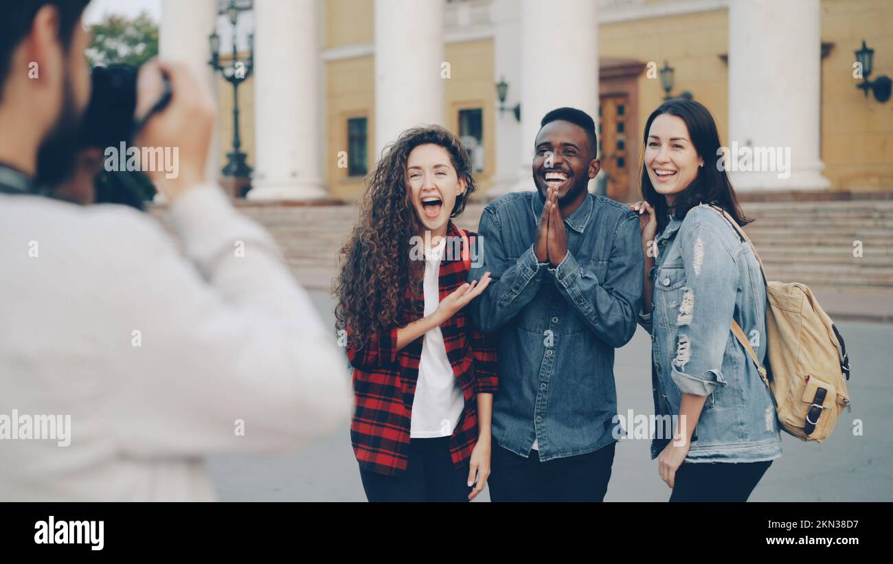 Multiethnic group of foreign tourists is taking photos posing for ...