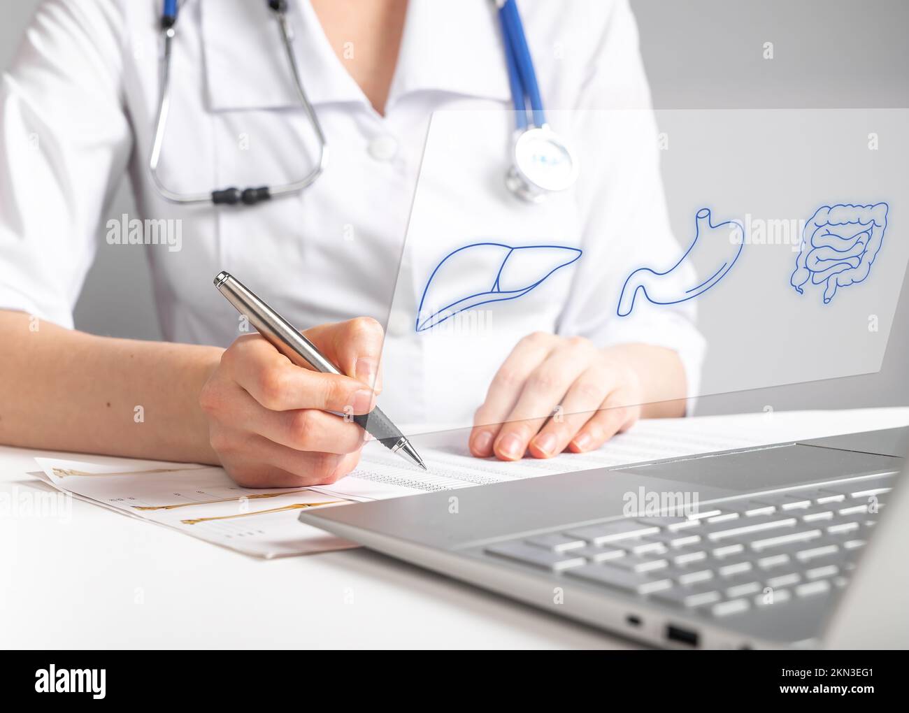 Gastroenterologist doctor works online, sitting at laptop with ...