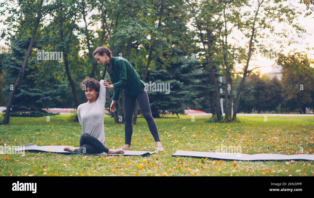 Diligent yoga student is learning Cow Face position sitting on mat and ...