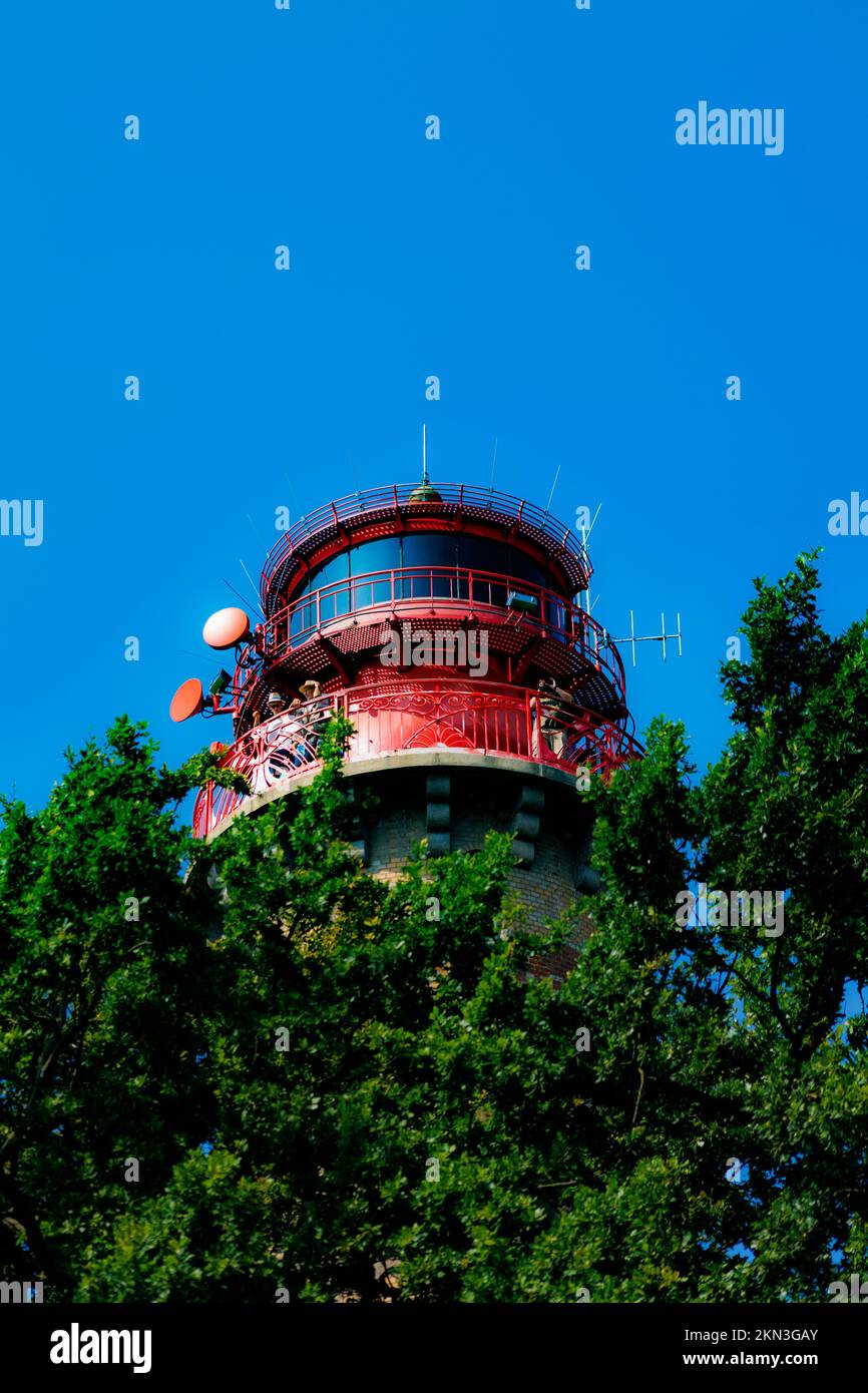 A low angle view of old lighthouse hidden in dense green woods Stock ...