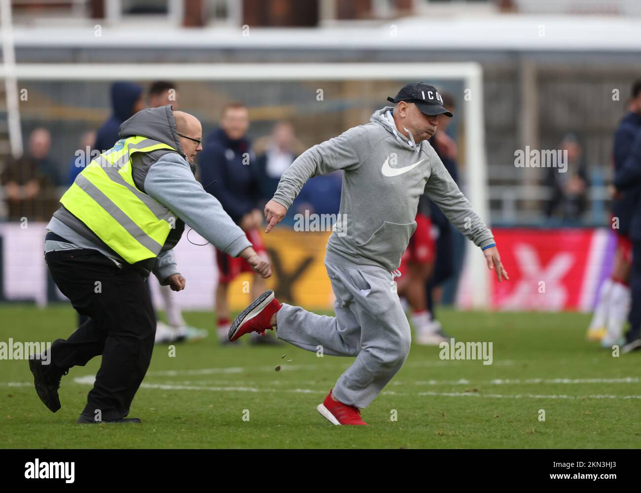 Kings Lynn, UK. 26th Nov, 2022. A pitch invader takes a tumble at the ...