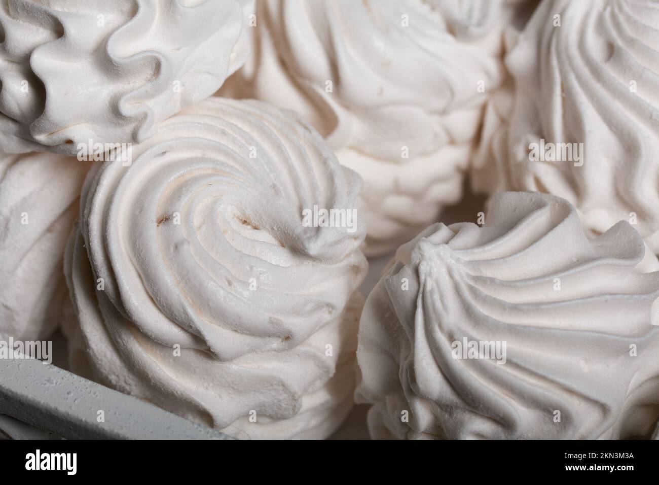 Homemade zephyr. White tray with marshmallows. Stands on black pine ...