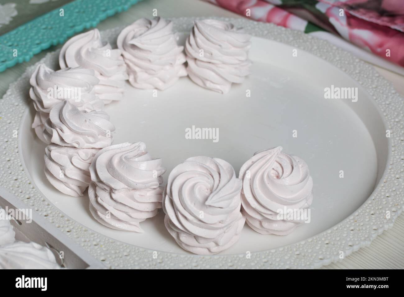 Homemade zephyr. White tray with marshmallows. Stands on black pine ...