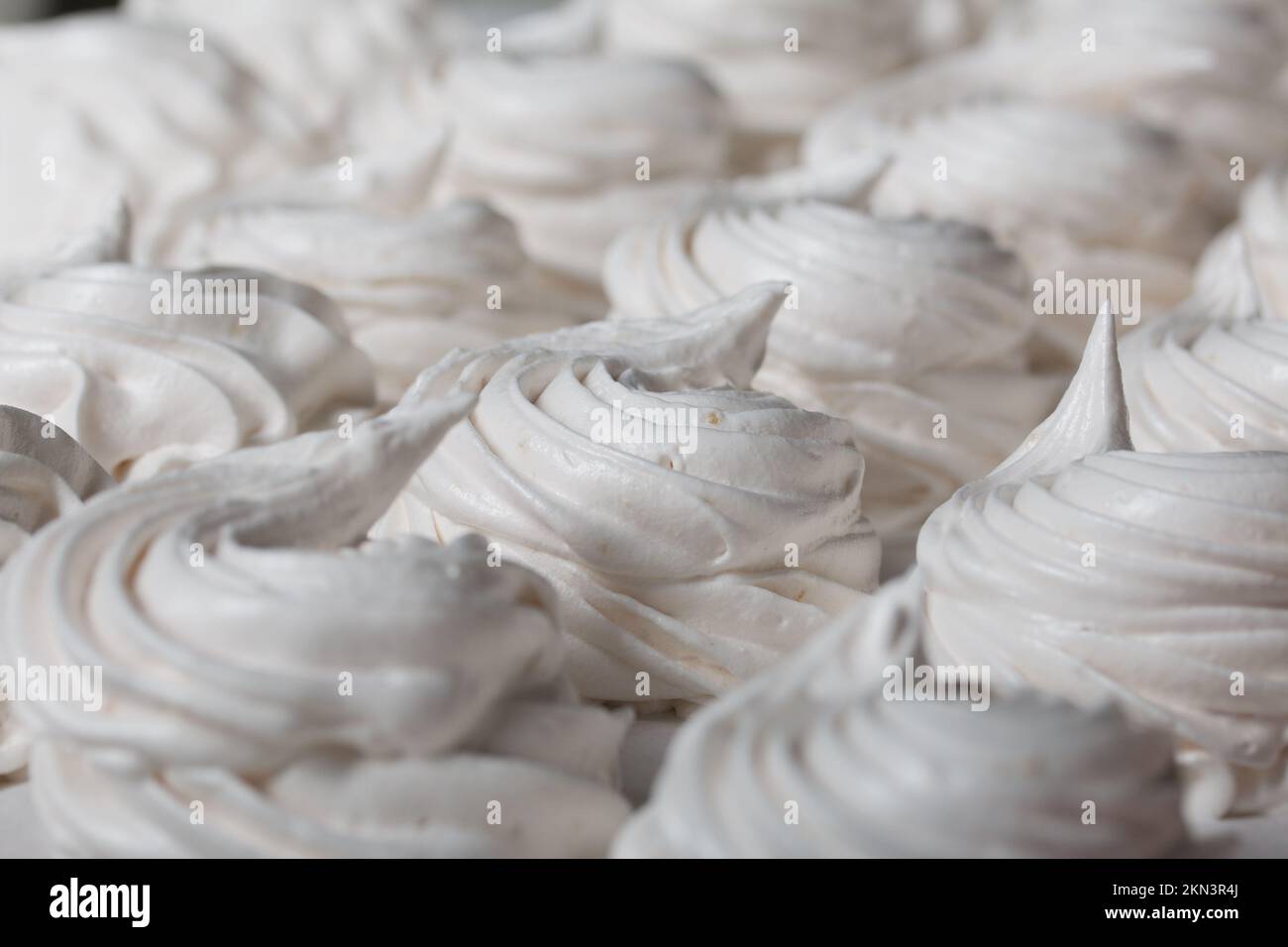 Homemade zephyr. White tray with marshmallows. Stands on black pine ...