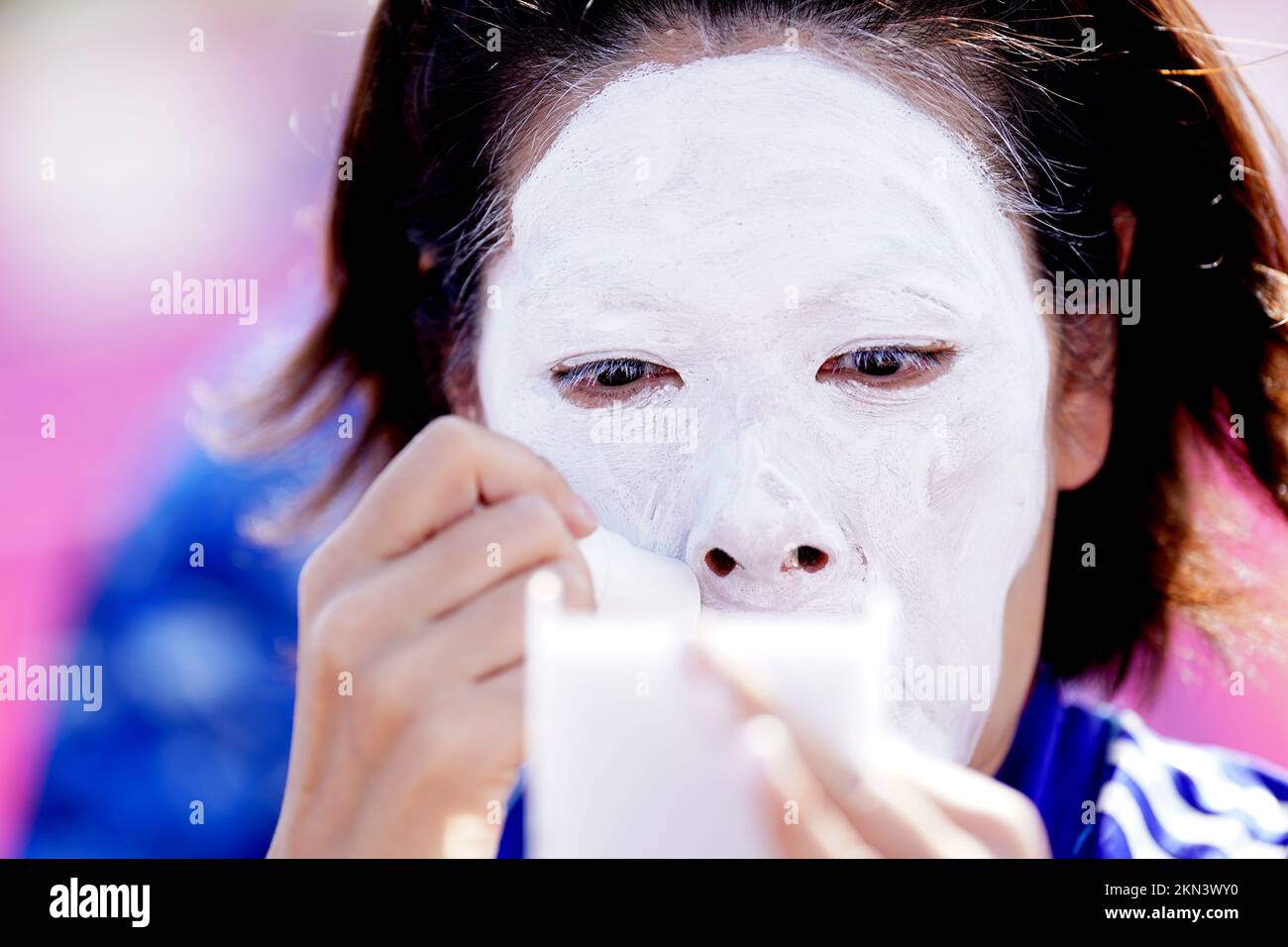 A Japan fan applies face paint ahead of the FIFA World Cup Group E ...