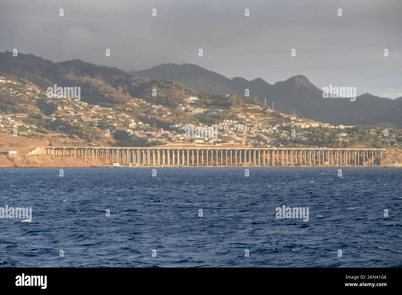 airport bridge runway on shore at Madeira island, shot in bright dawn ...