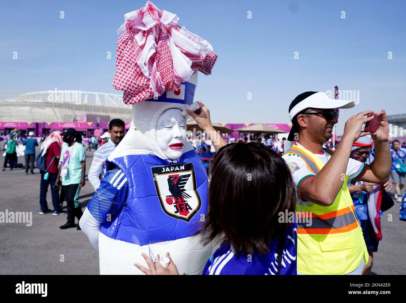 Japan fans apply face paint to complete their match day attire, ahead ...