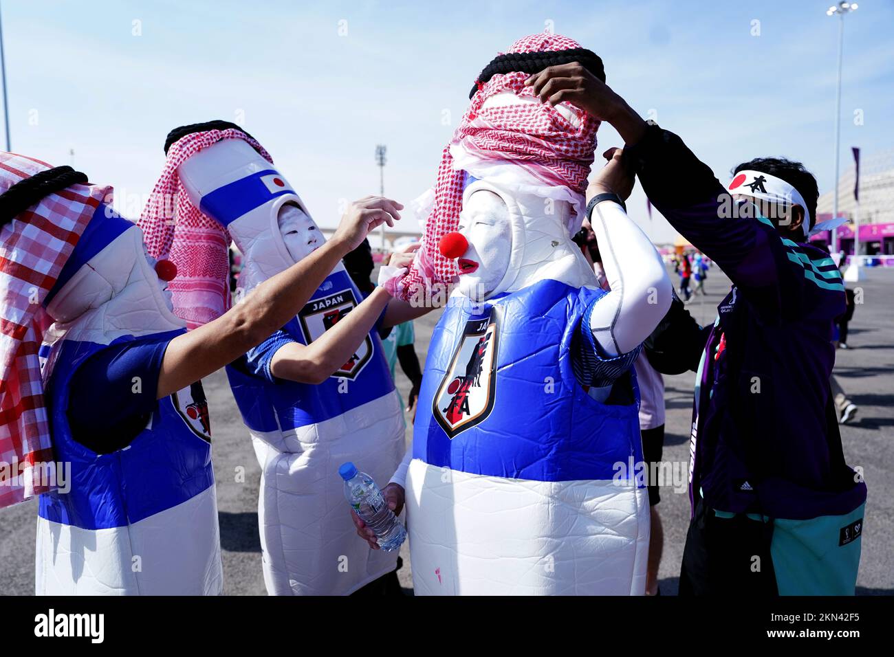 Japan fans apply face paint to complete their match day attire, ahead ...