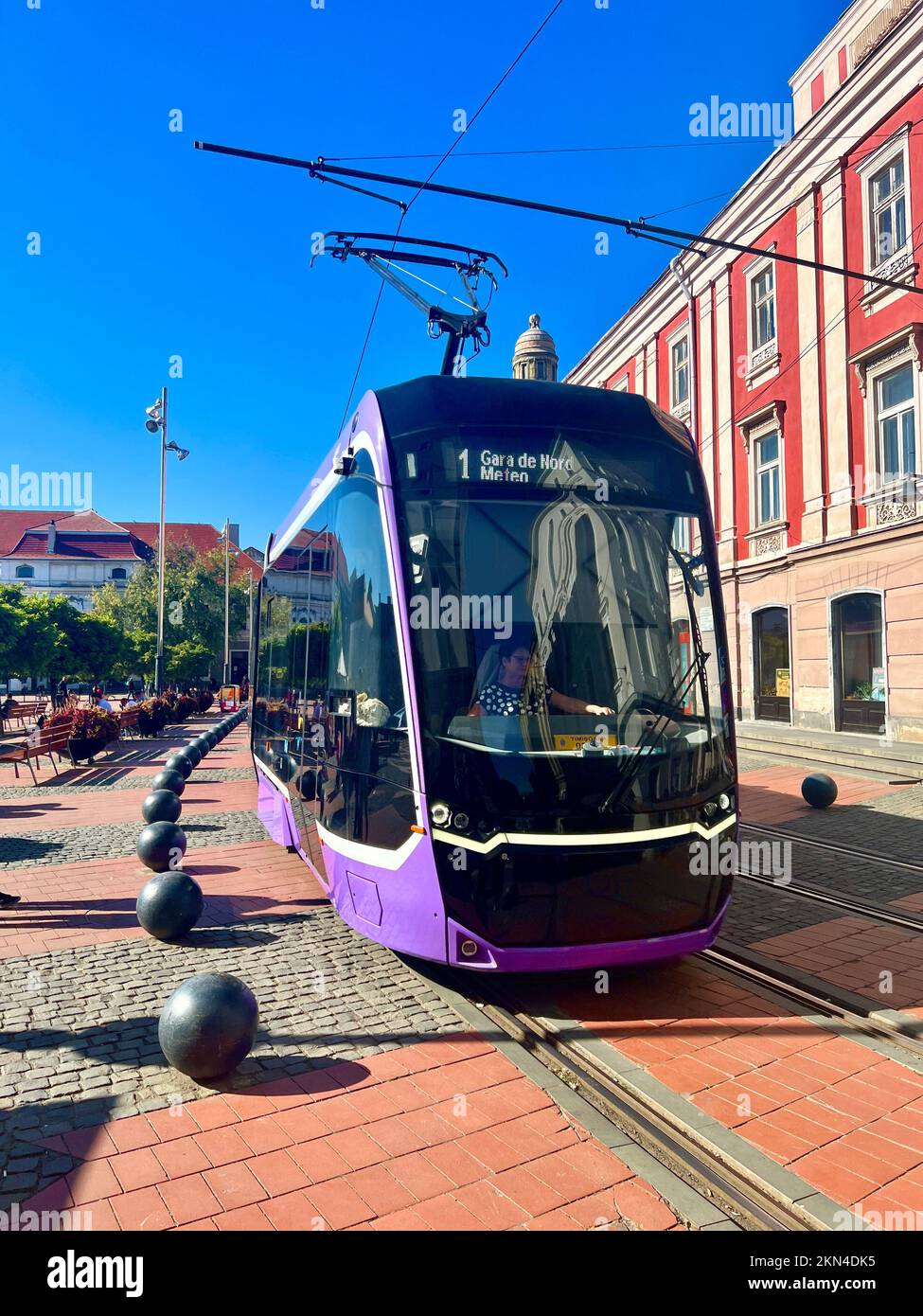 A vertical shot of a purple public tram in Timisoara, Romania in sunny ...