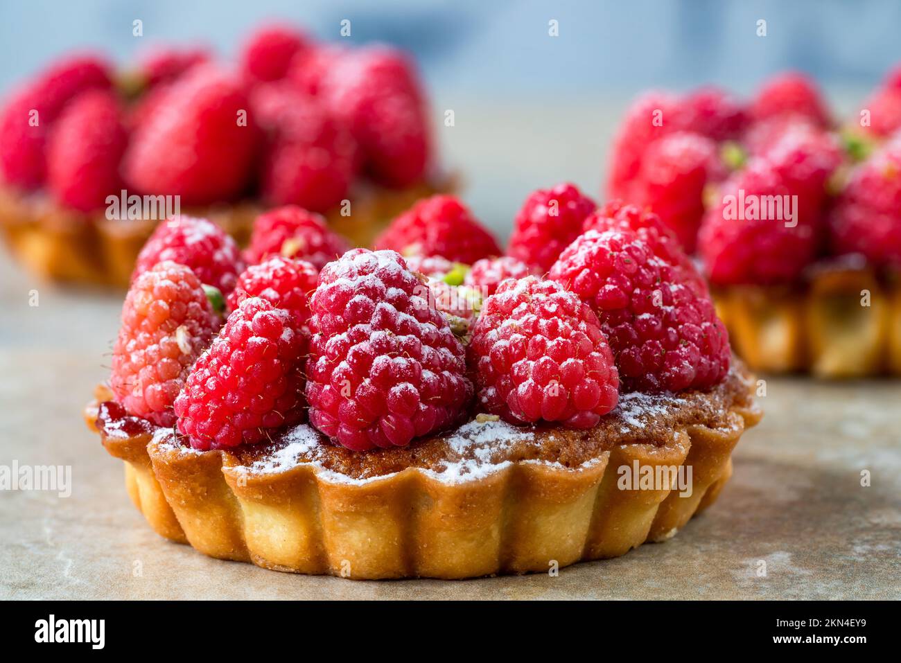Raspberry and pistachio tarts Stock Photo - Alamy