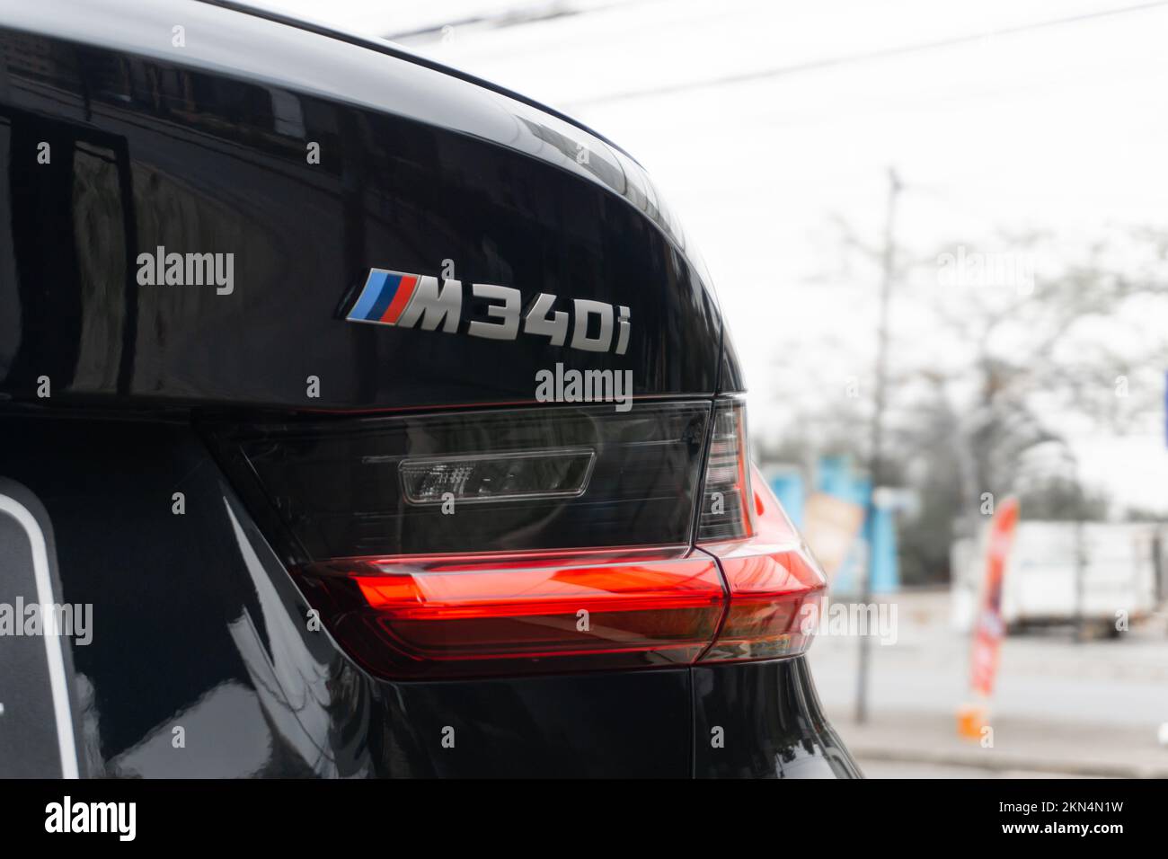 A closeup rear view of a black BMW M340i model badge Stock Photo - Alamy