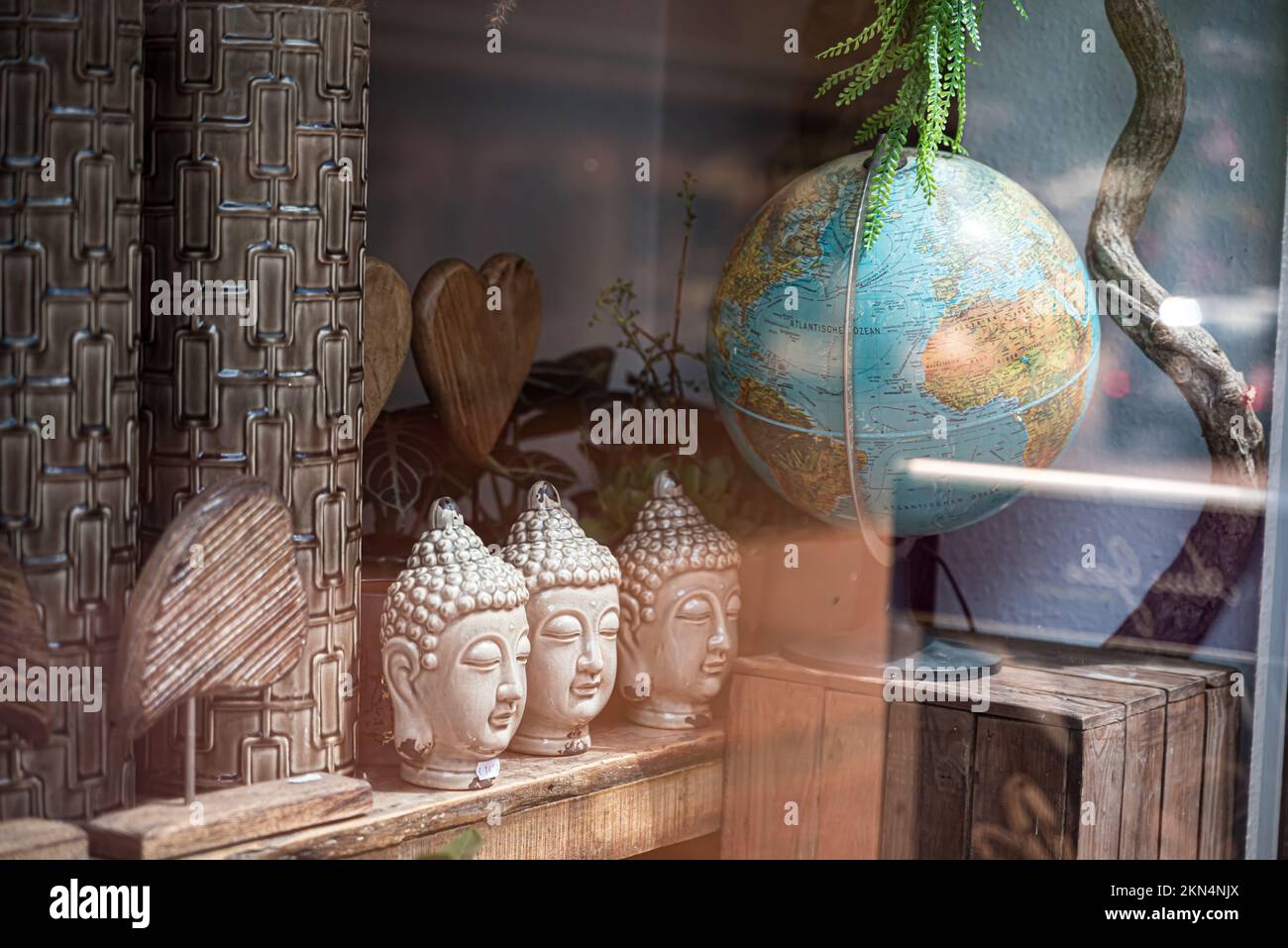 A display of the Buddha statue behind a shop window Stock Photo - Alamy