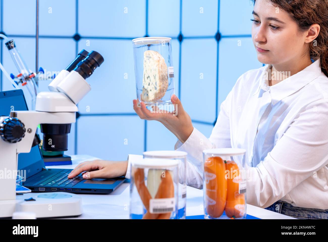 young woman in food and food quality control laboratory examine the ...