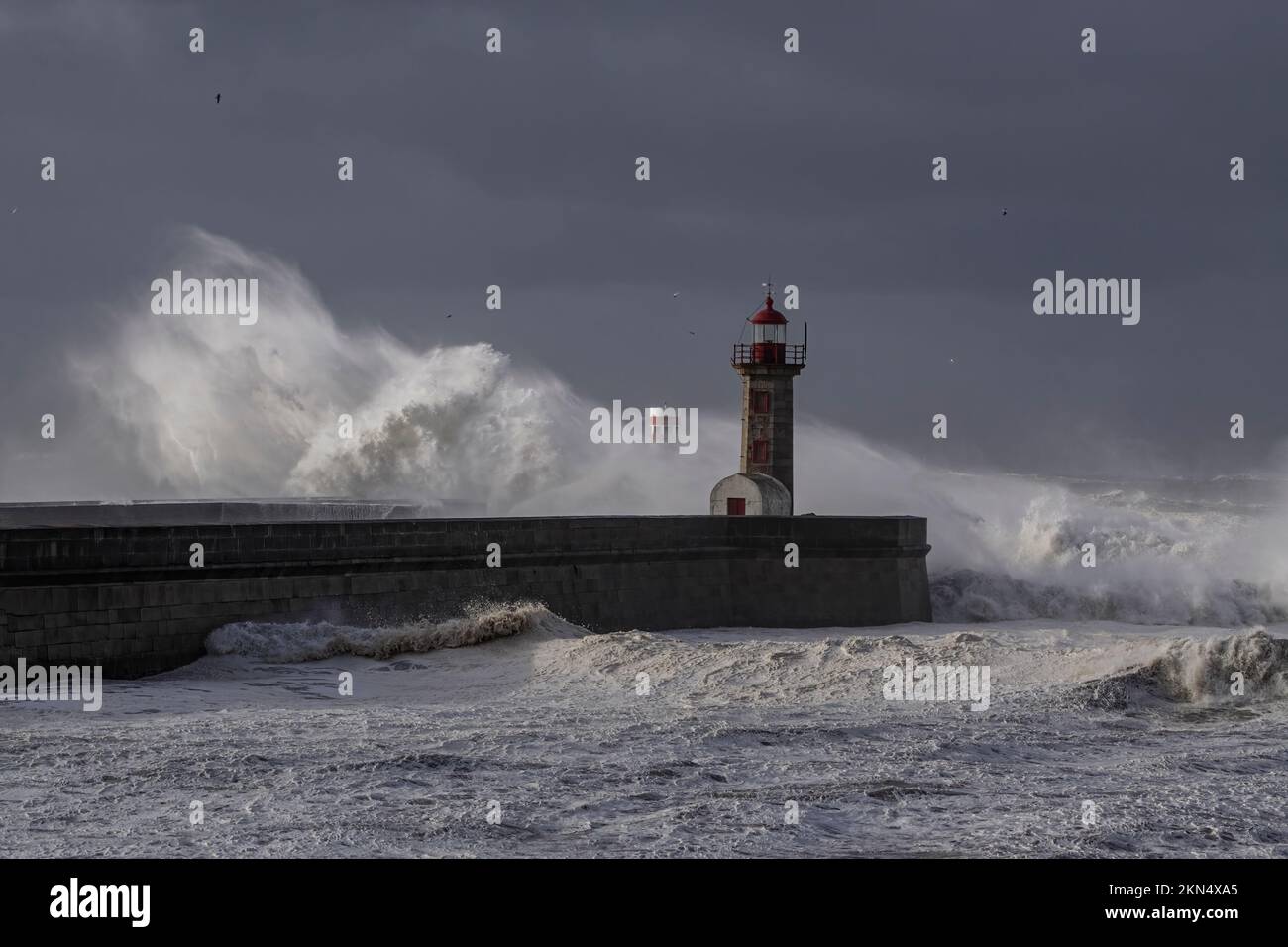 Huge stormy wave splash. Douro river mouth old lighthouse and granite ...
