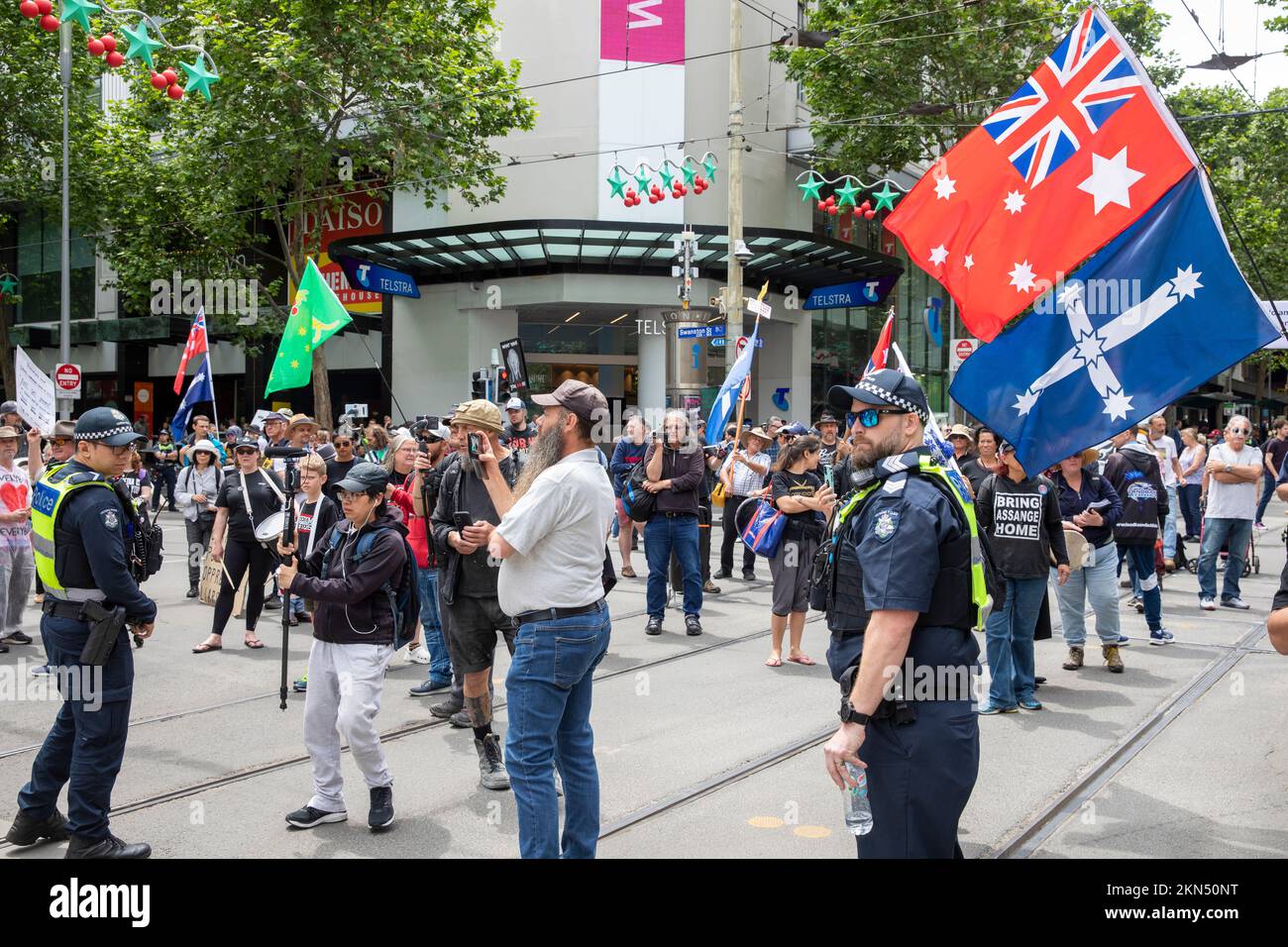 Victorian pOlice officers monitor protestors in Melbourne city centre ...