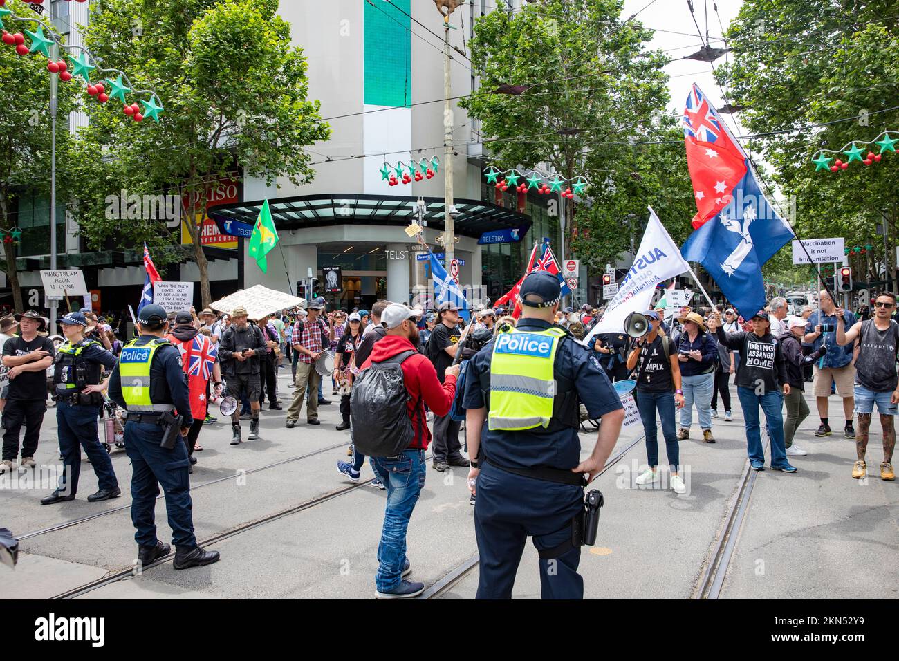 Victorian pOlice officers monitor protestors in Melbourne city centre ...