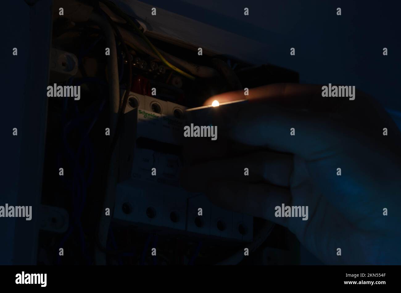 Blackout concept. Person's hand in complete darkness holding a holding ...