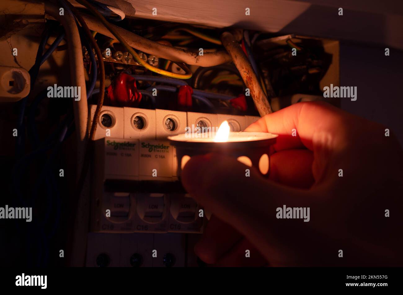 Blackout concept. Person's hand in complete darkness holding a holding ...