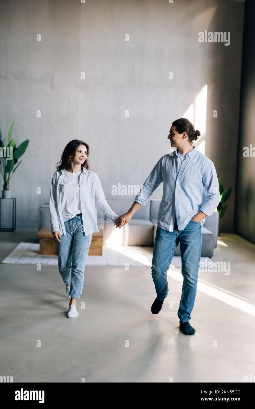 Beautiful young couple in living at home Stock Photo - Alamy