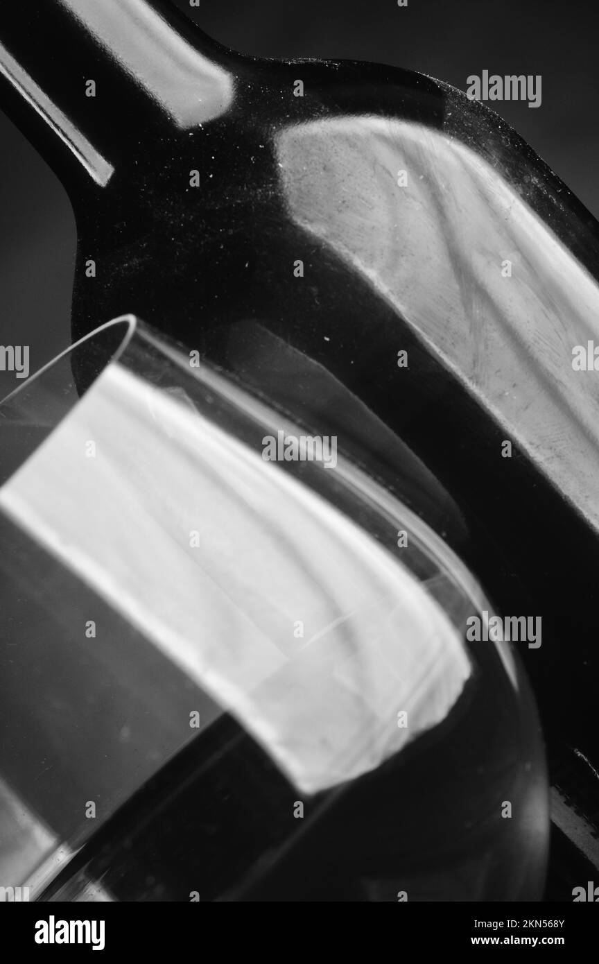 Wine bottle and glass on table Black and White Stock Photos & Images ...