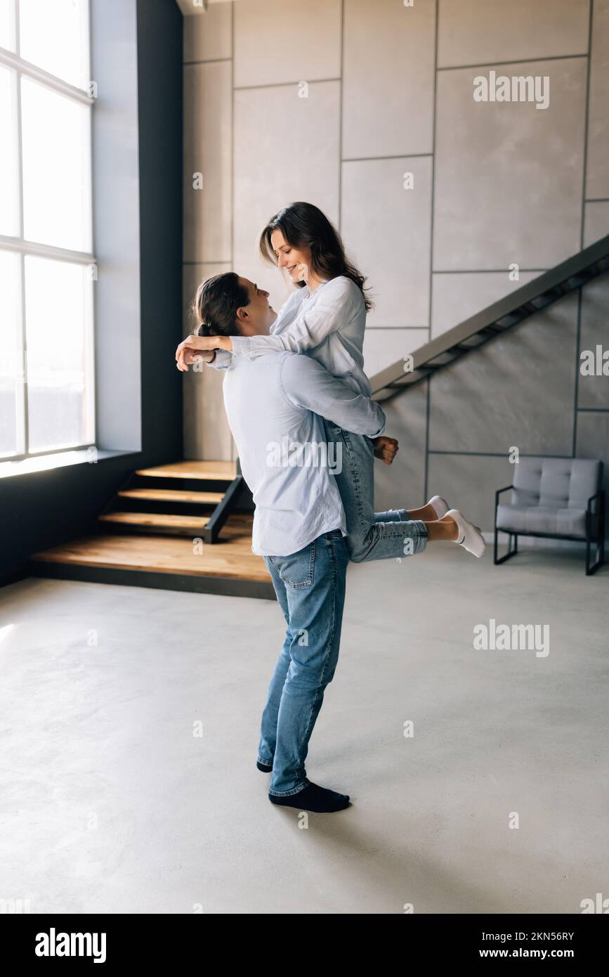 Happy loving couple kissing feeling excited about moving into new home ...